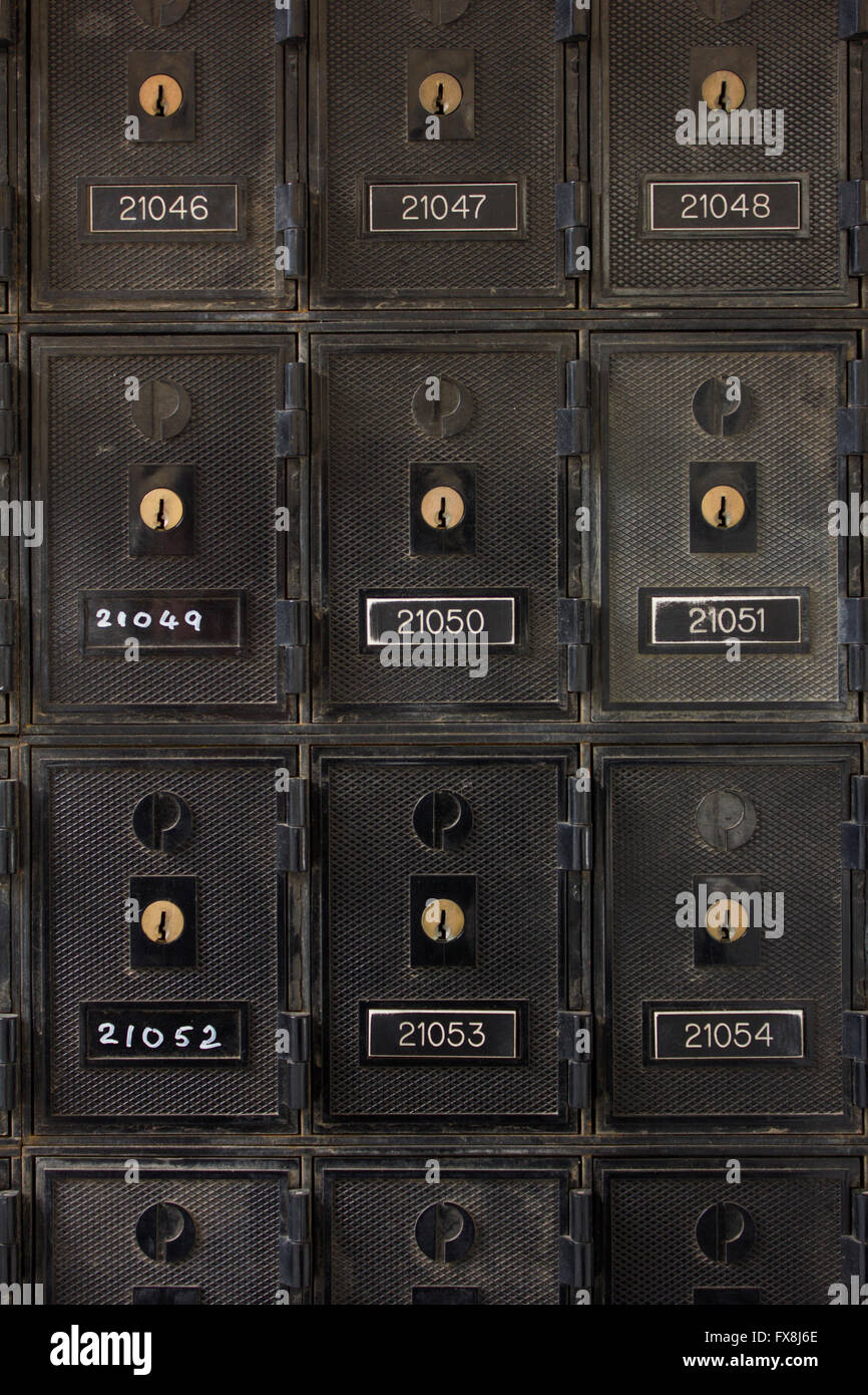 A group of nine wall mounted letter boxes at the post office. Slot mail ...