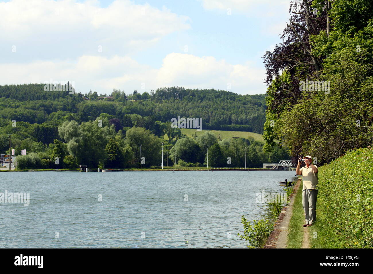 Tourist filming with a camcorder the Meuse at Blaimont. Belgian ...