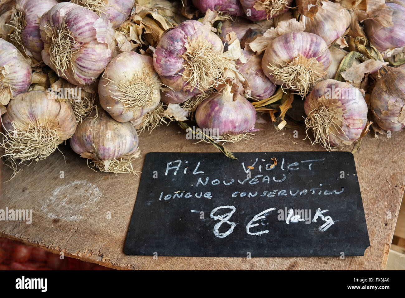 Braided strands with bulbs of Garlic at a market in Brittany, France ...