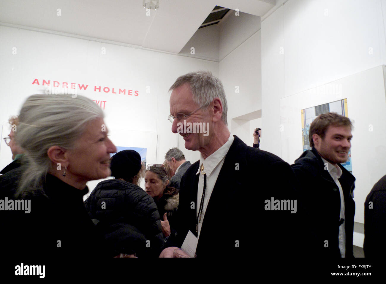 Artist Andrew Holmes talking to friends at the opening of his ...