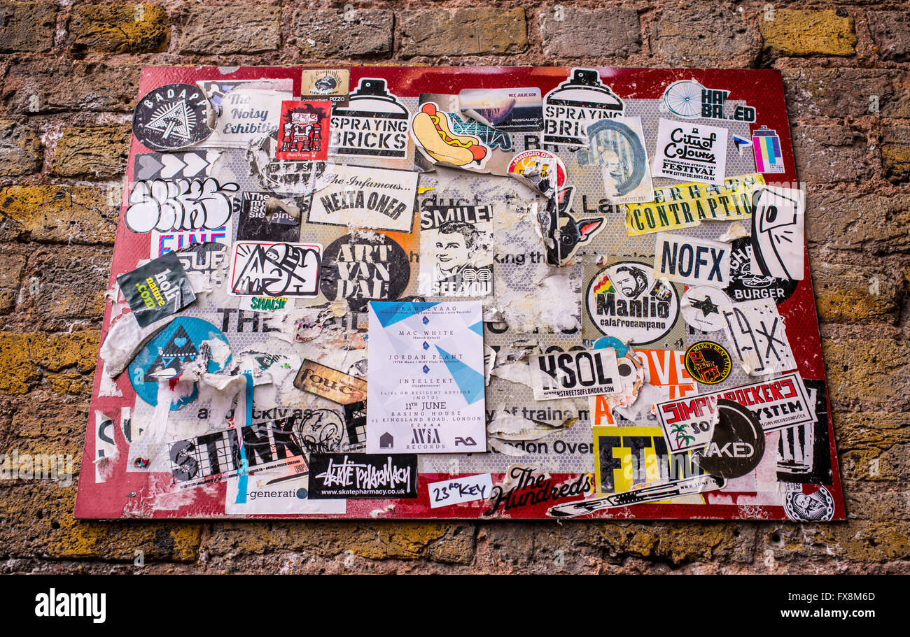 Square street sign covered in graffiti, scribbles and stickers in the ...