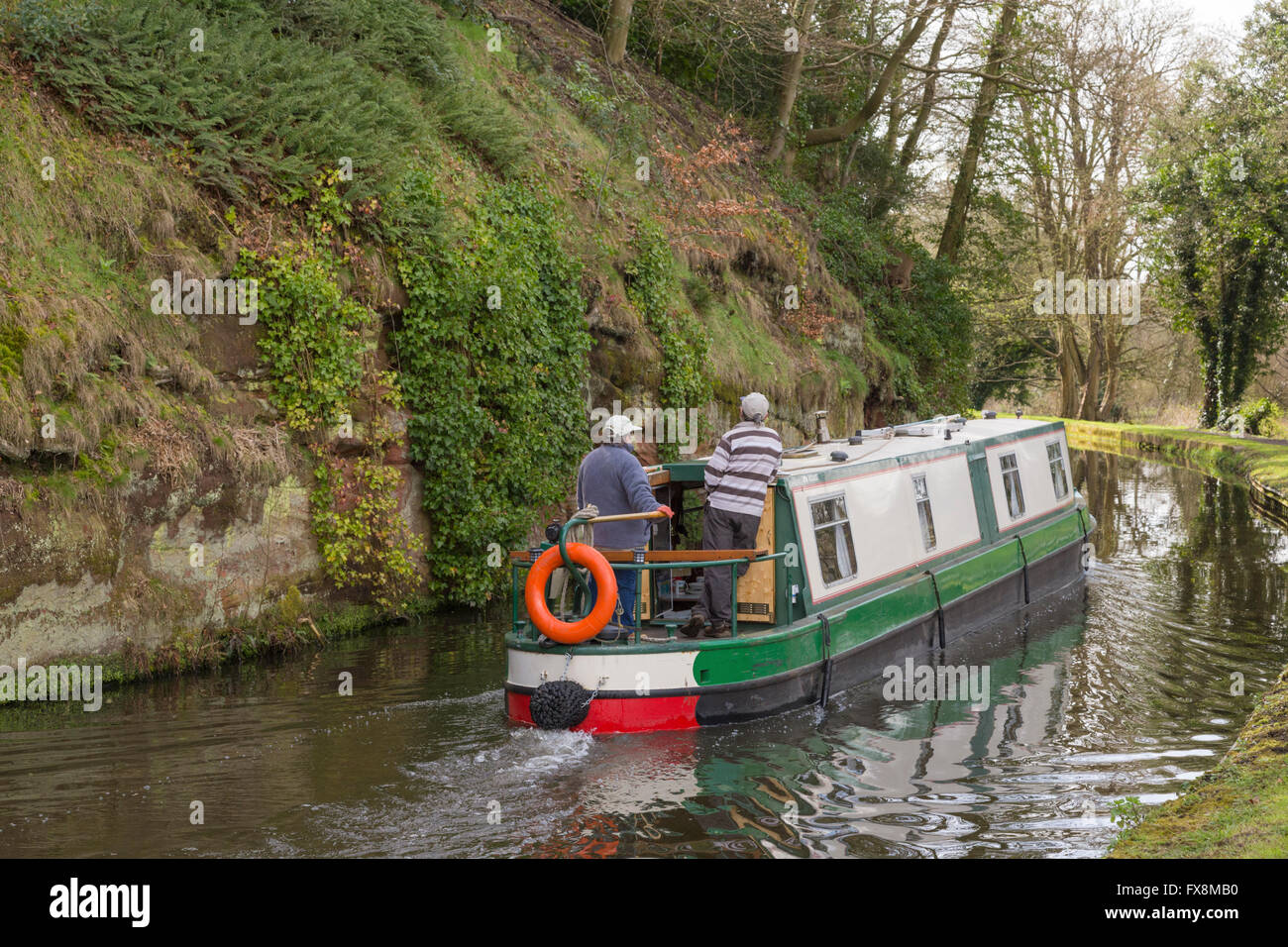 Narrowboat navigating a sandstone cutting on the Staffs and Worcester ...