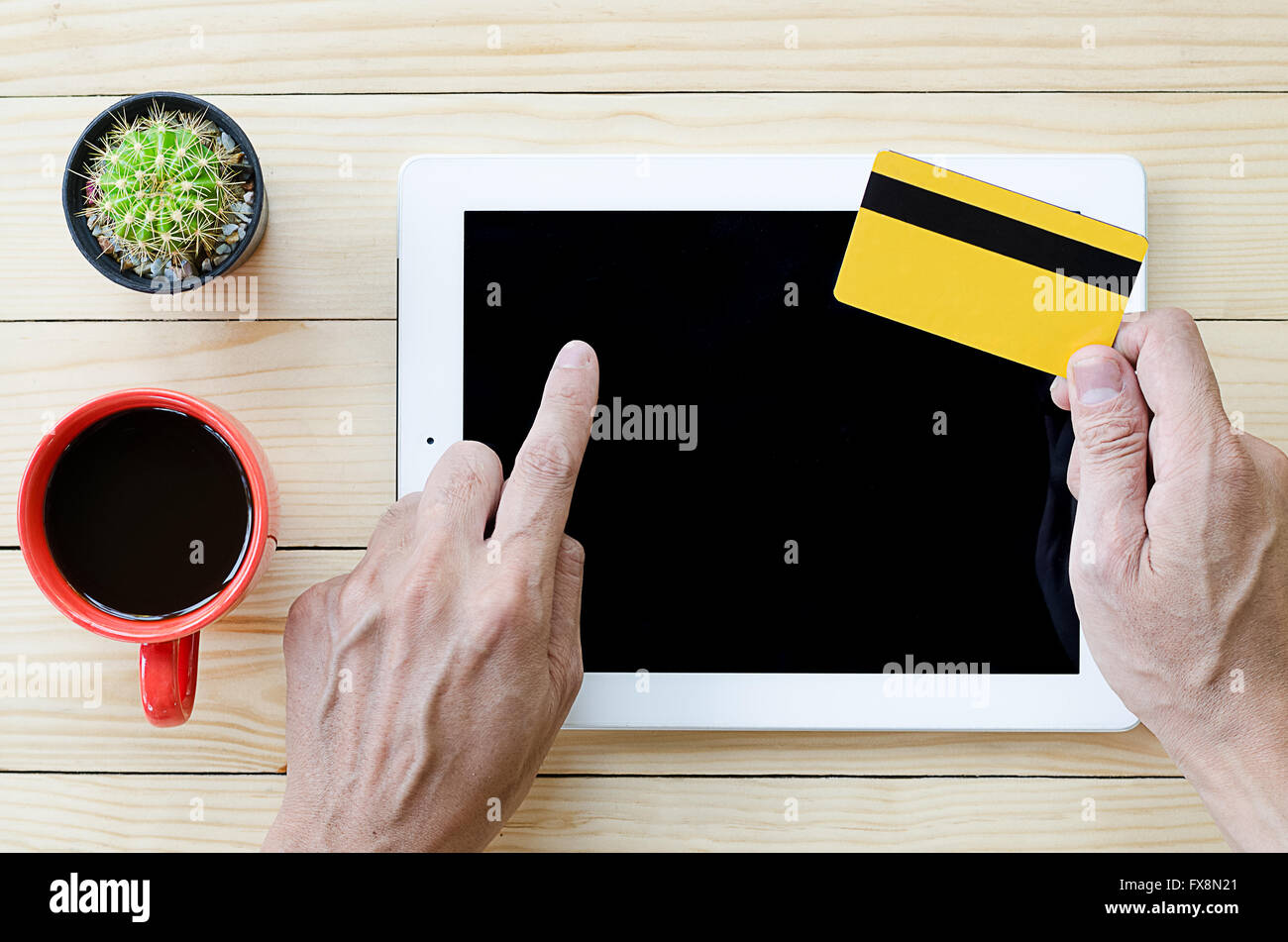 Man using credit card and digital tablet computer for buying on line ...