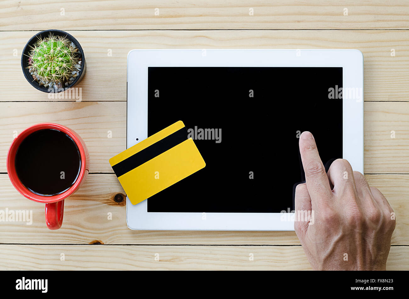 Man using credit card and digital tablet computer for buying on line ...