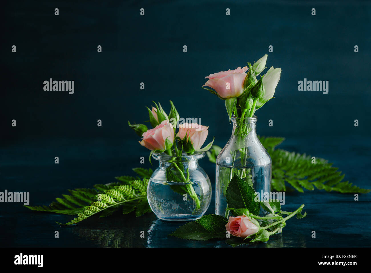 Cut roses with ferns and dew Stock Photo - Alamy