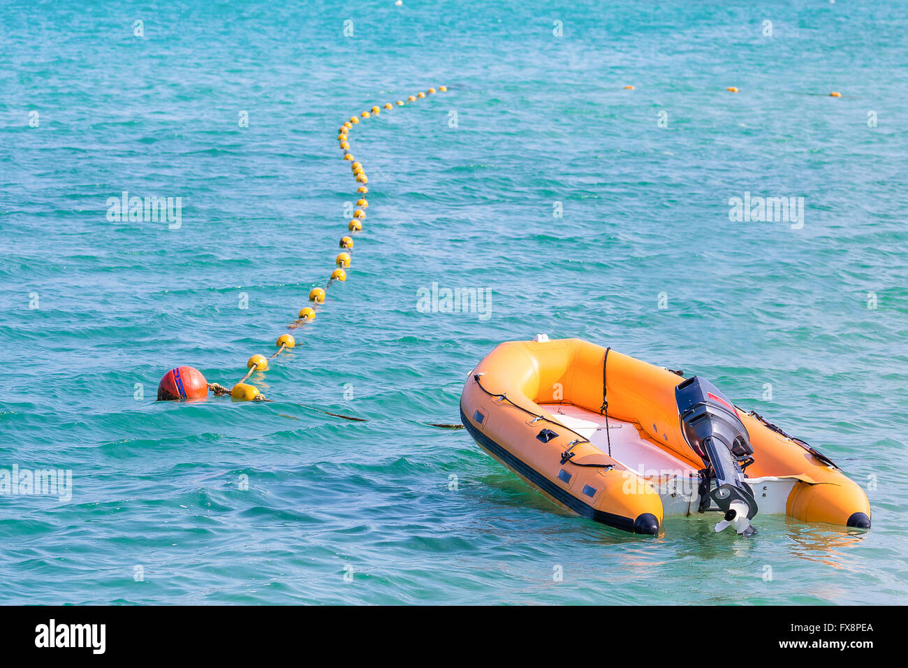 Inflated plastic speed boat floating on the shallow beach Stock Photo ...