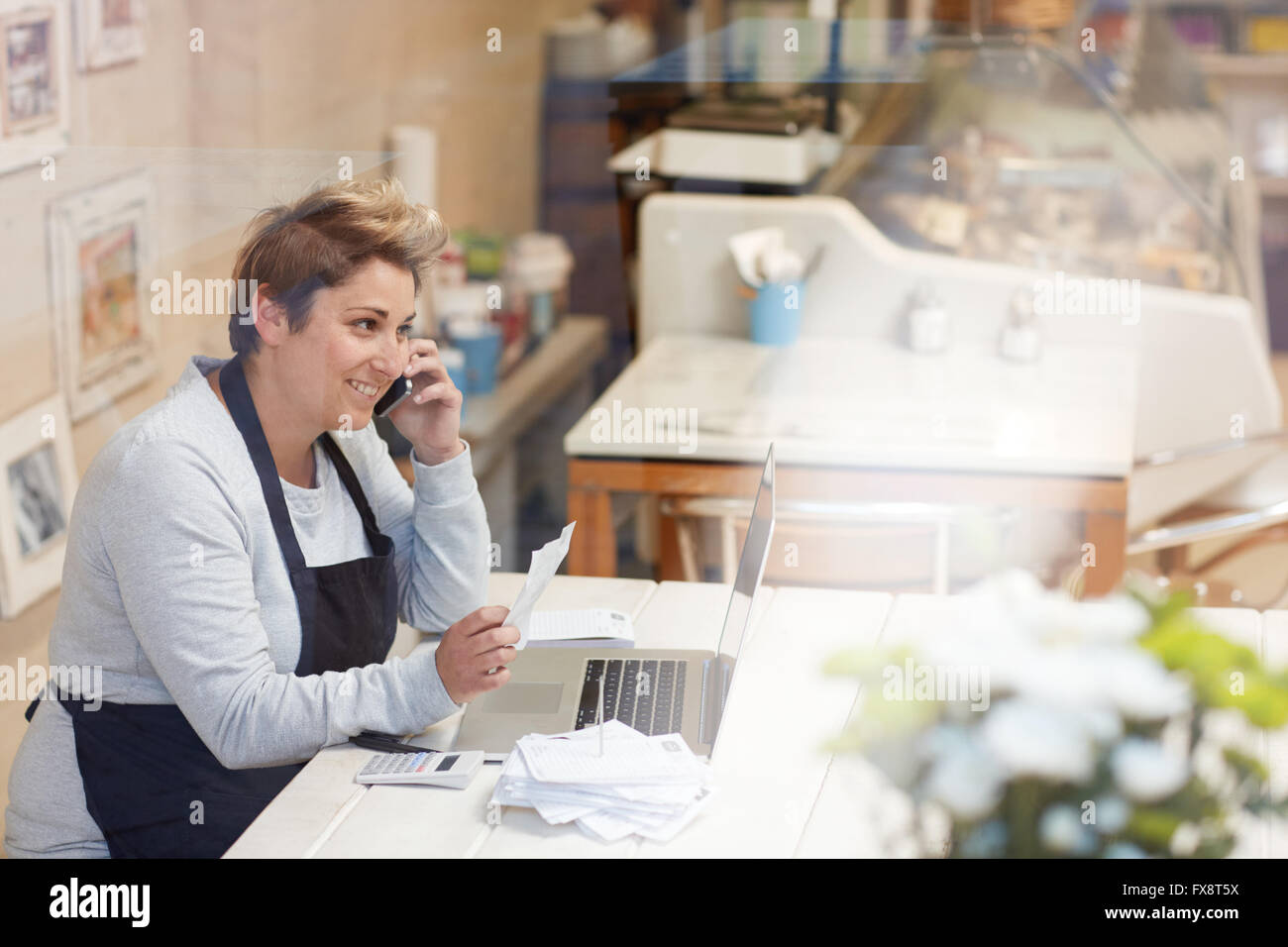 Calling her partner about the cash-up Stock Photo - Alamy