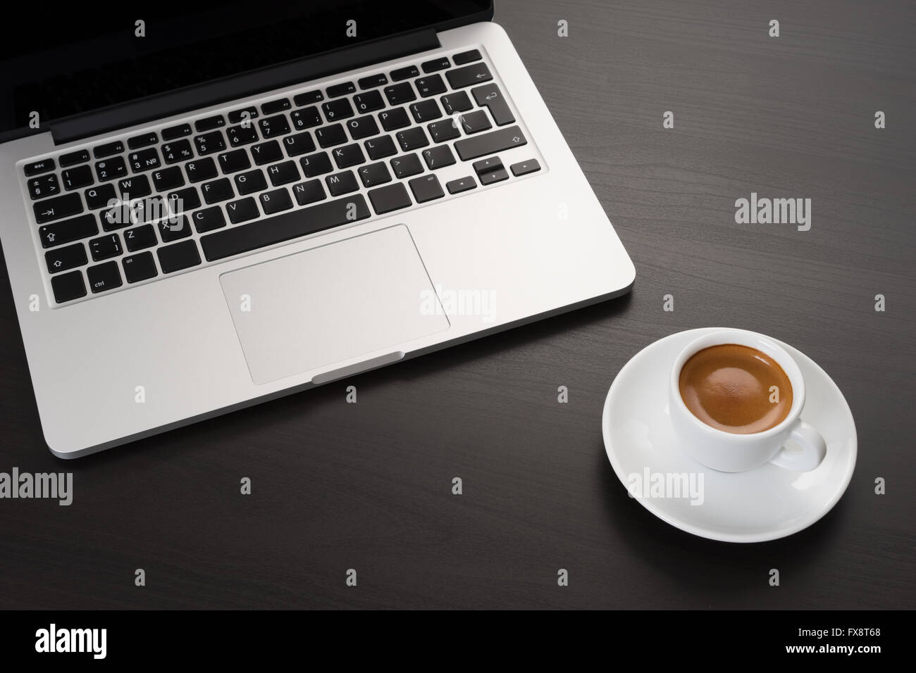 Laptop and coffee on office table Stock Photo - Alamy