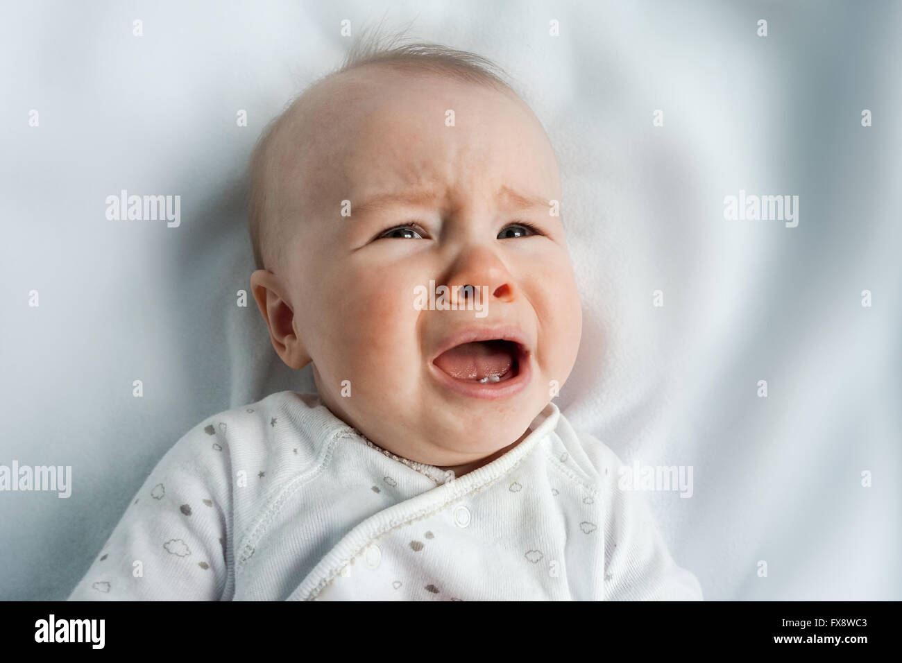 A teething baby Stock Photo - Alamy