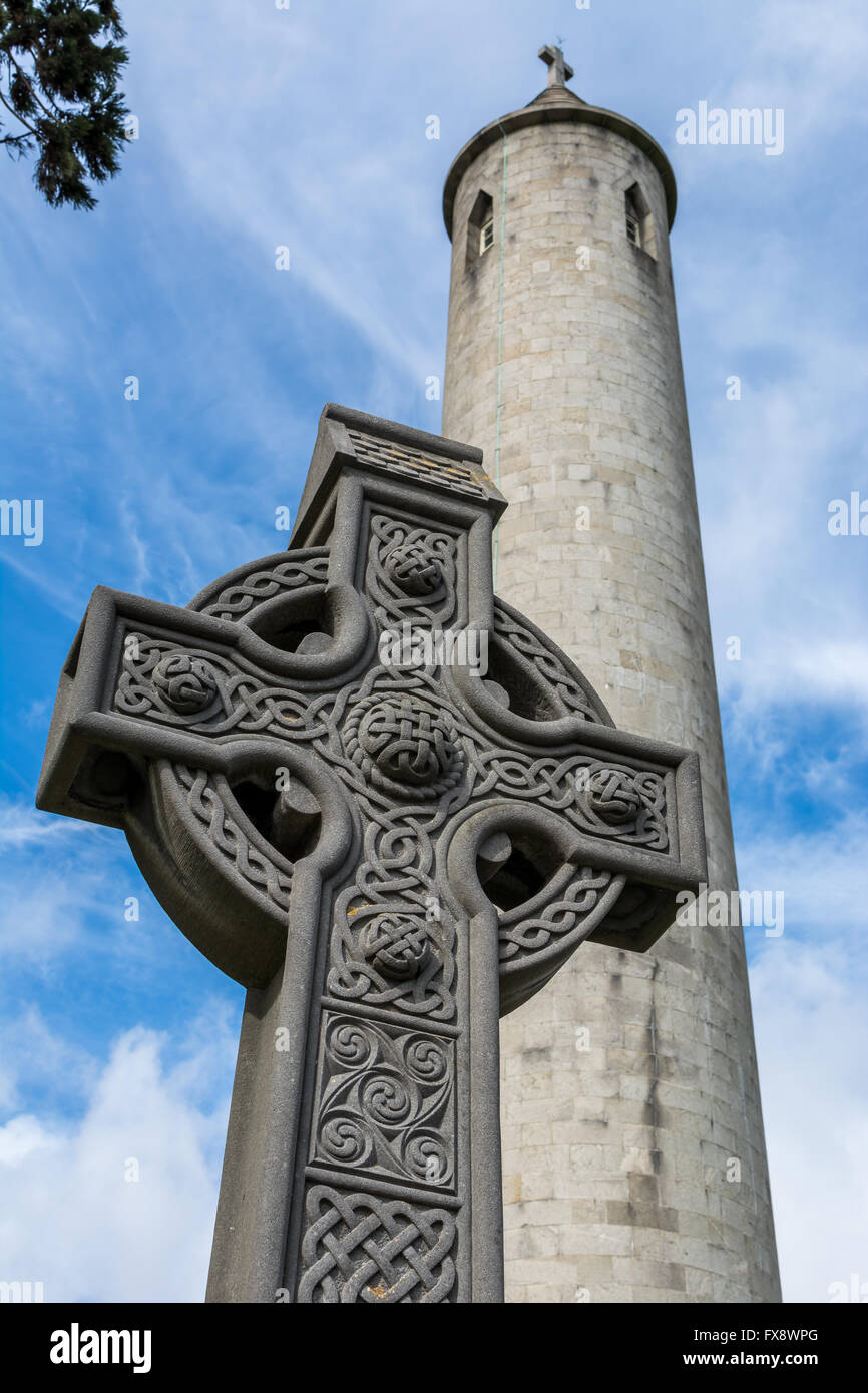 A stone Celtic Cross stands above a grave in Glasnevin cemetery in ...