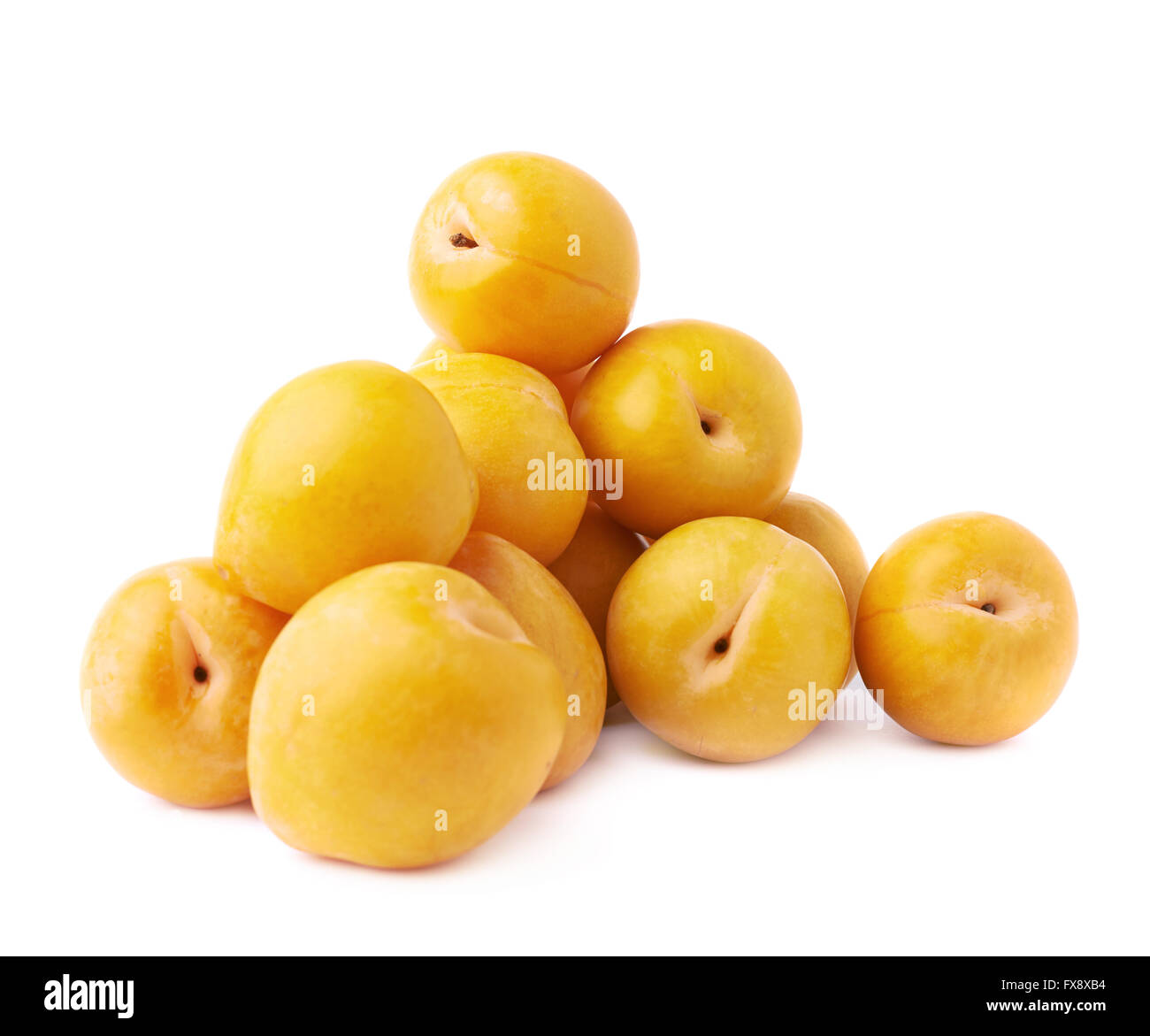 Pile of multiple yellow plums isolated Stock Photo - Alamy