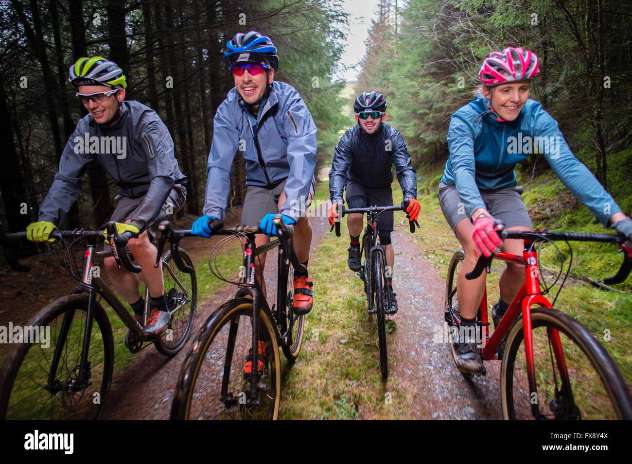 A group of friends cycling together In the hills and woodlands around ...