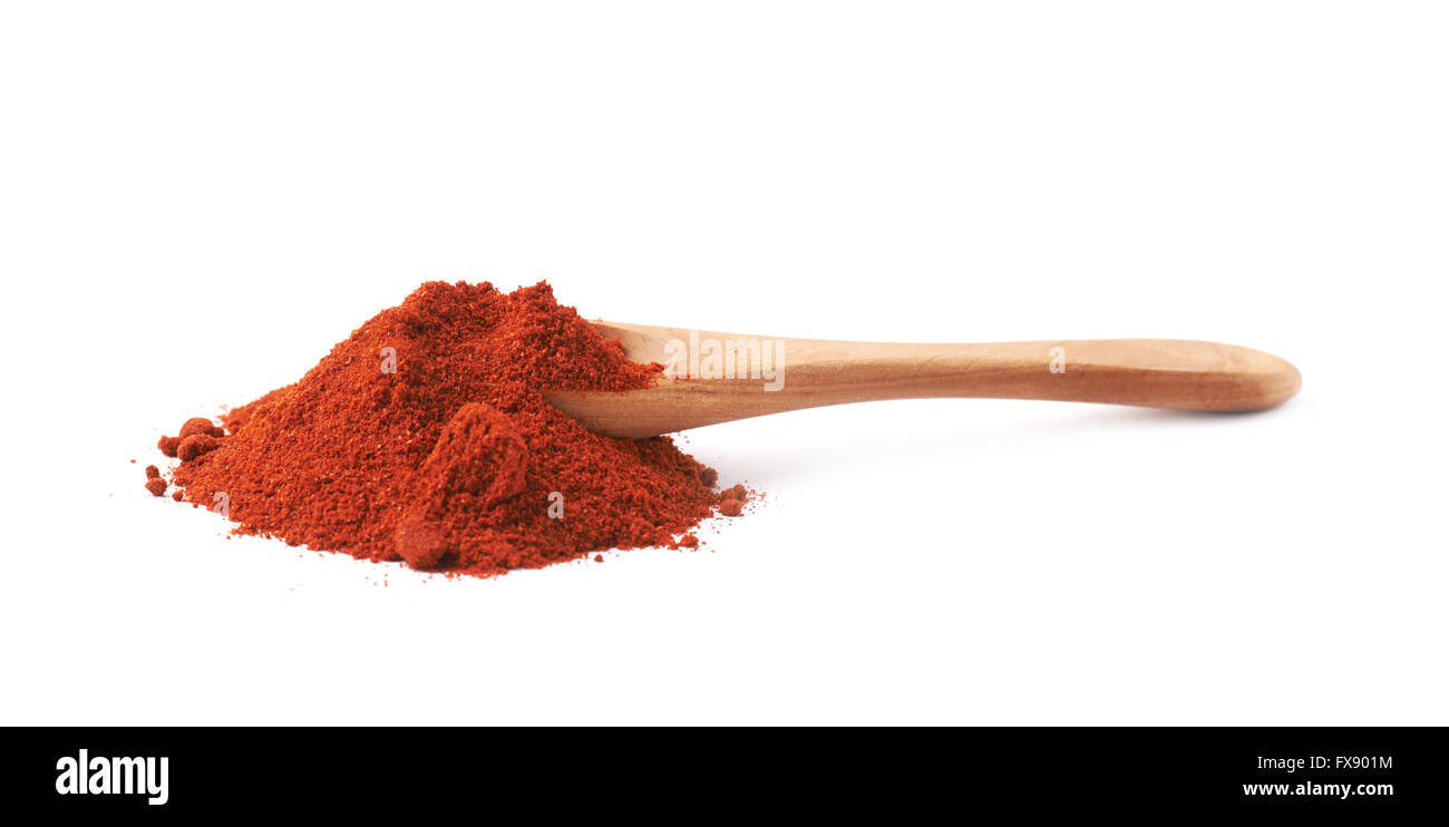 Spoon covered with chili powder isolated Stock Photo - Alamy