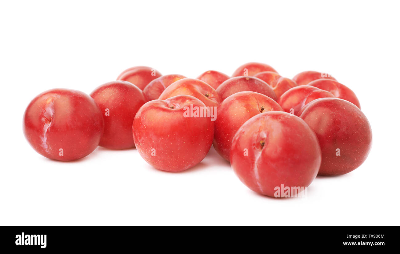 Pile of multiple red plums isolated Stock Photo - Alamy