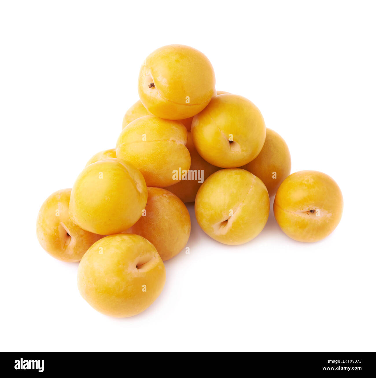 Pile of multiple yellow plums isolated Stock Photo - Alamy