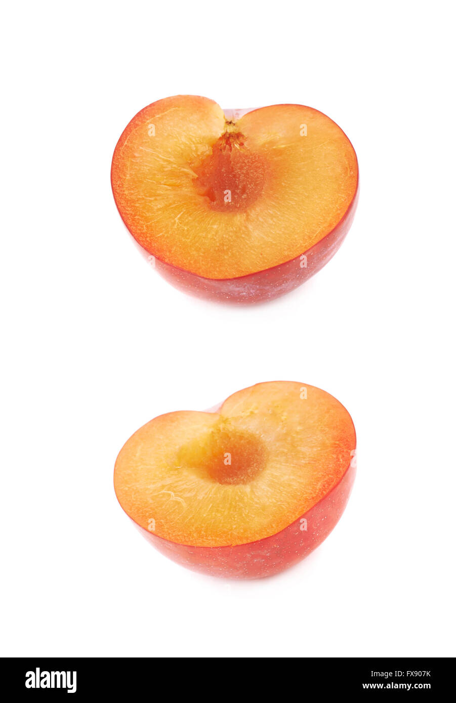 Cut open plum half isolated Stock Photo - Alamy
