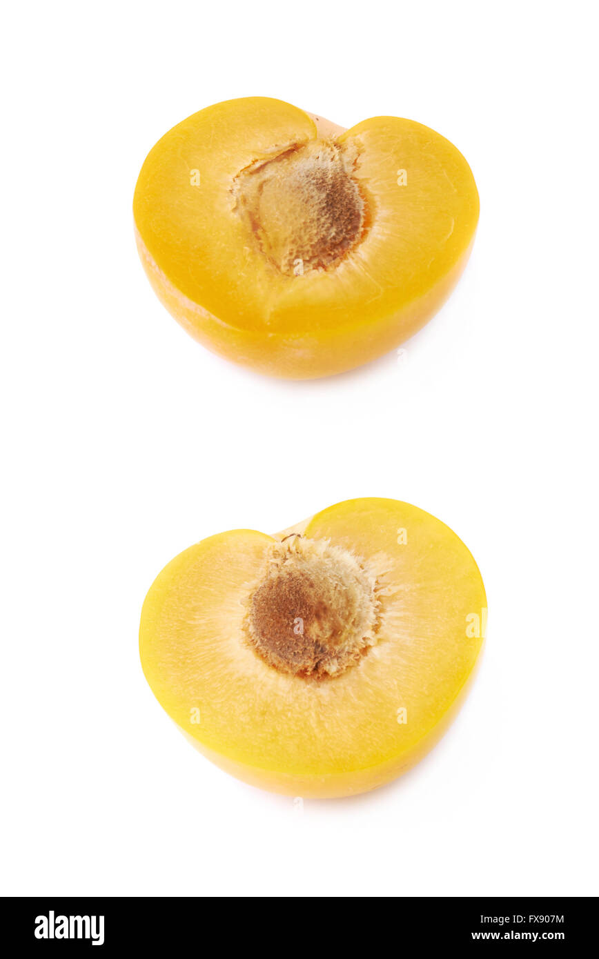Cut open plum half isolated Stock Photo - Alamy