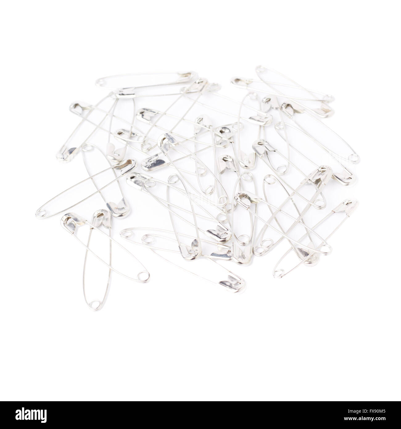Surface covered with multiple safety pins isolated on white background ...