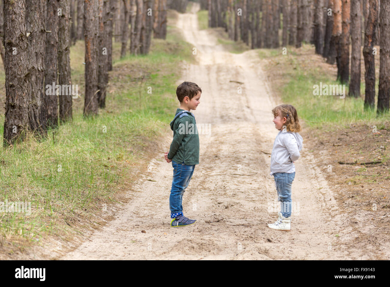 Two children walking road hi-res stock photography and images - Alamy