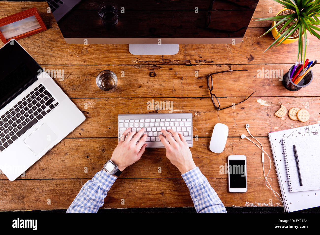 Business person working at office desk wearing smart watch Stock Photo ...