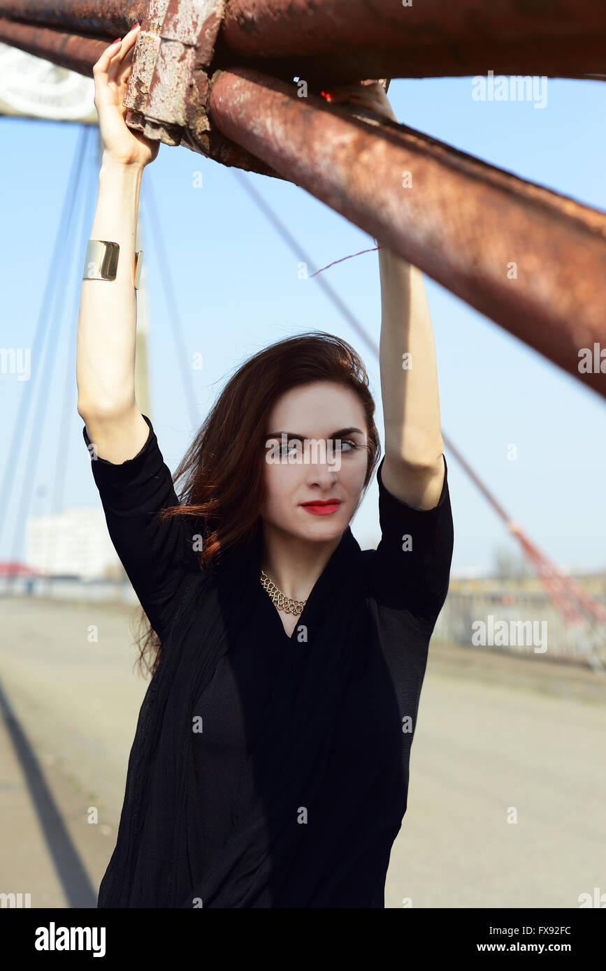 Beautiful brunette girl on the bridge Stock Photo - Alamy