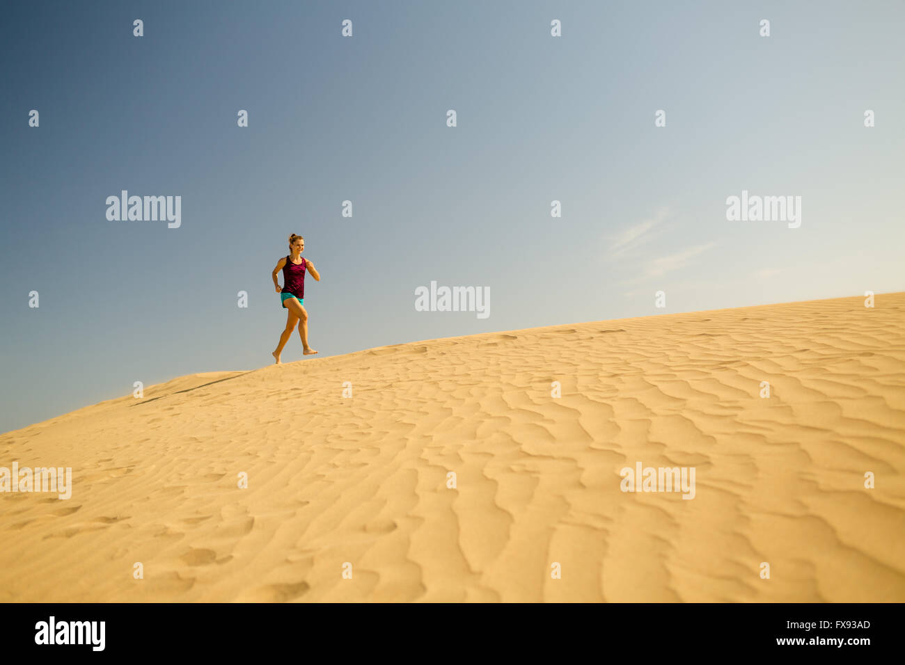 Young woman running on beautiful inspirational desert dunes on sunny ...