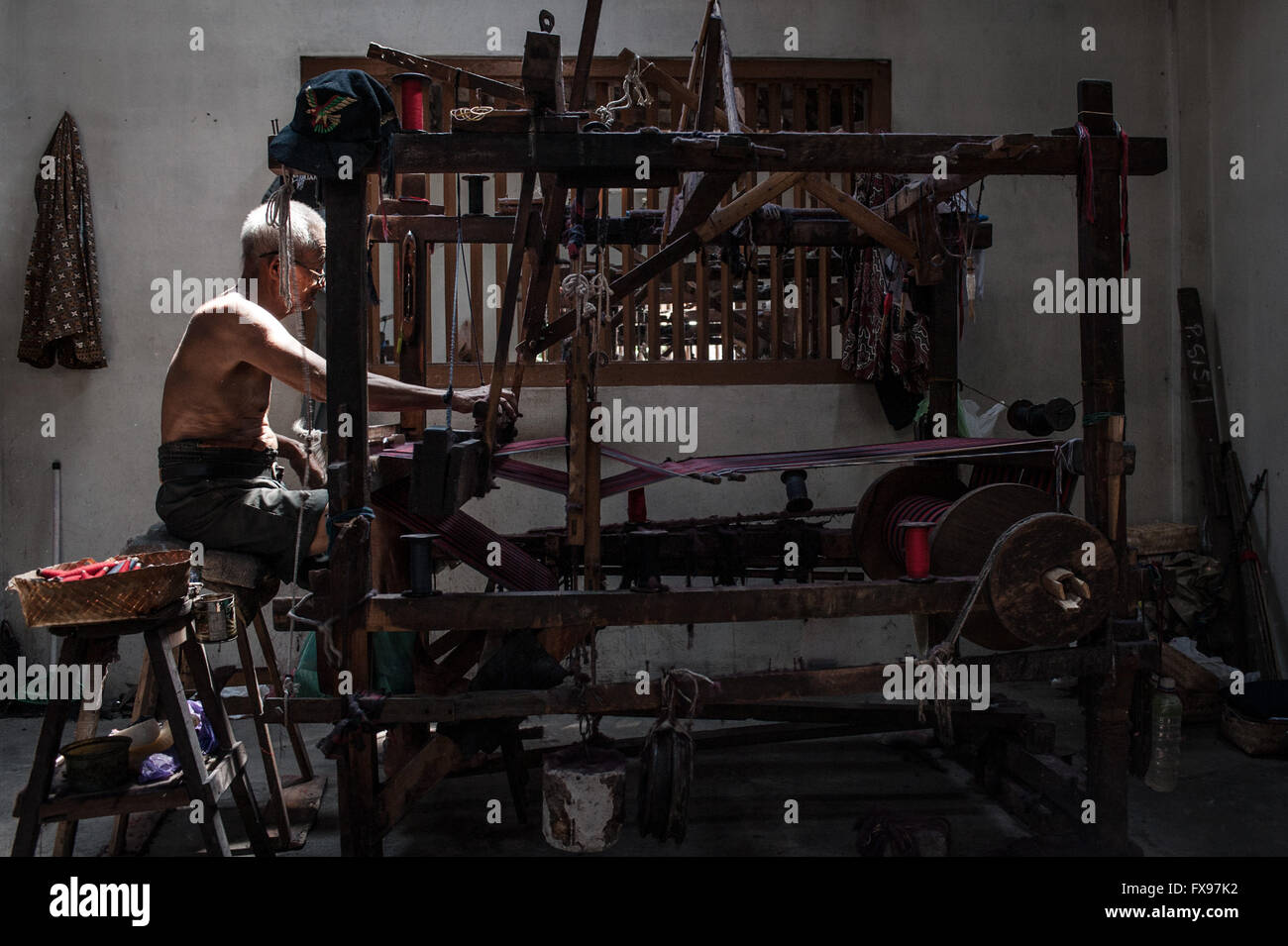 Yogyakarta, Indonesia. 12th Apr, 2016. An old man weaves the Lurik ...