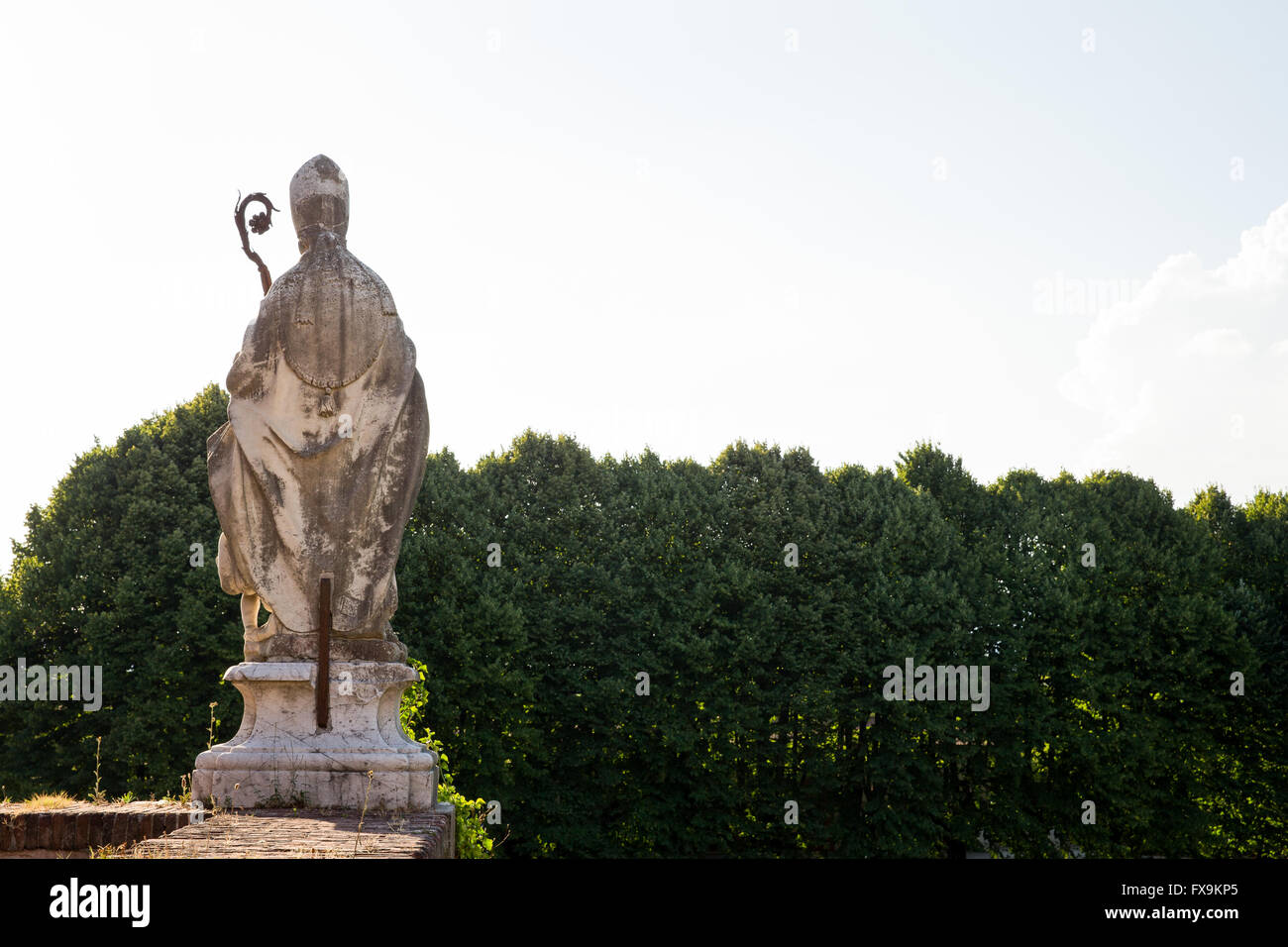 Ancient statue of a bishop holding a staff. Placed atop the medieval ...