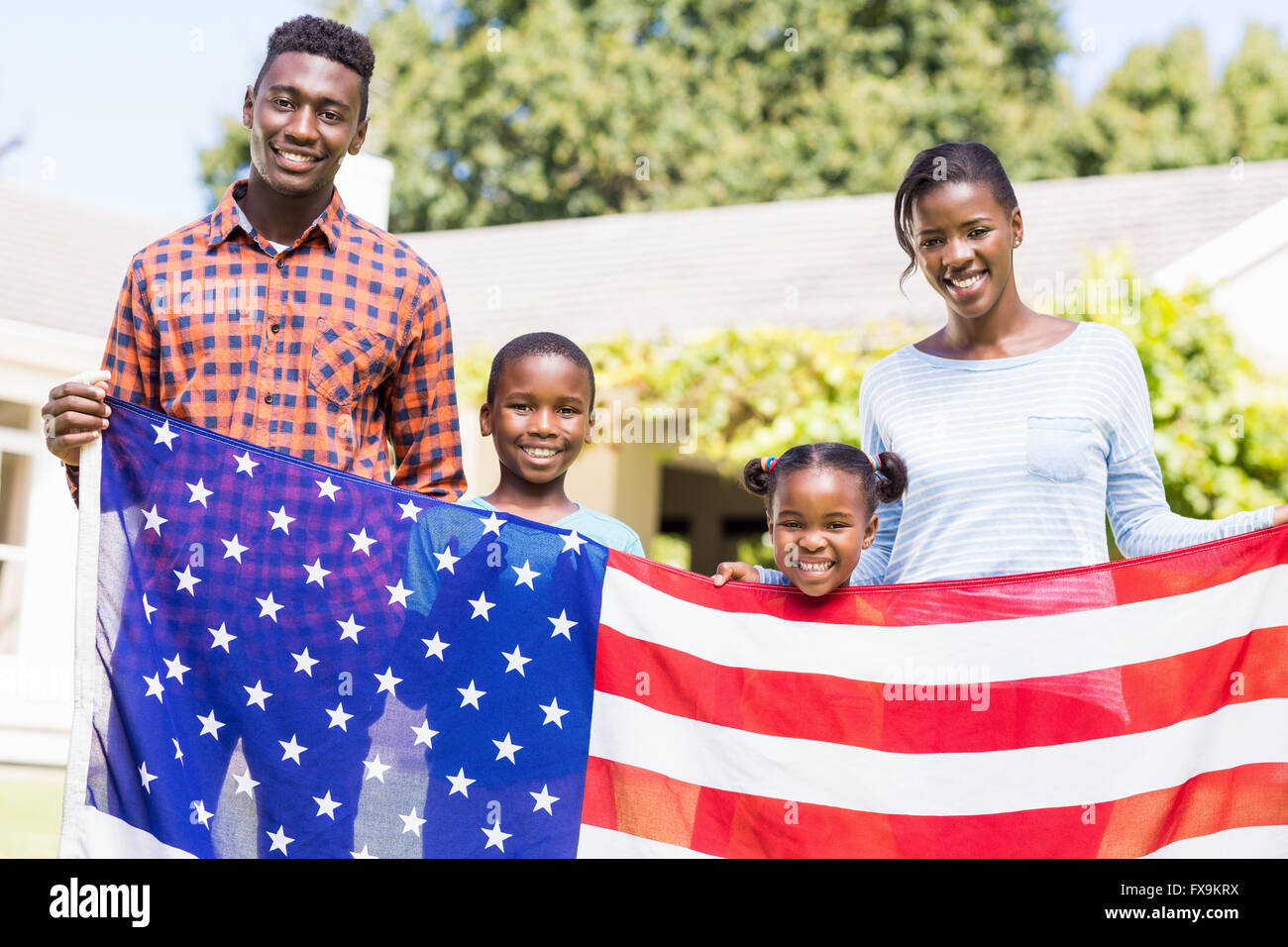 Happy family showing usa flag Stock Photo - Alamy