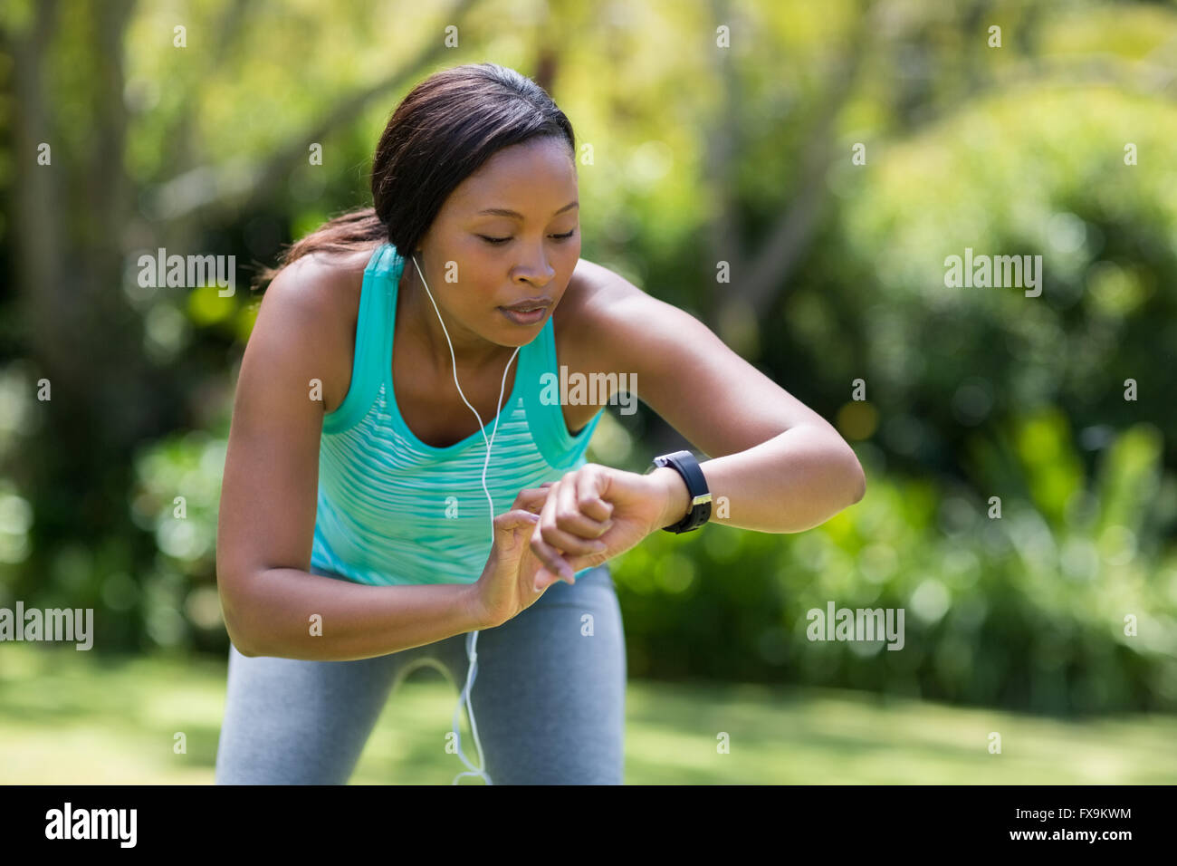 Woman looking her watch Stock Photo - Alamy