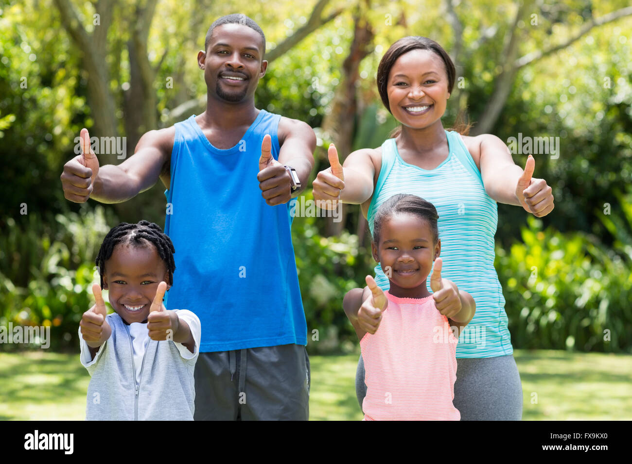 Happy family doing thumbs up Stock Photo - Alamy
