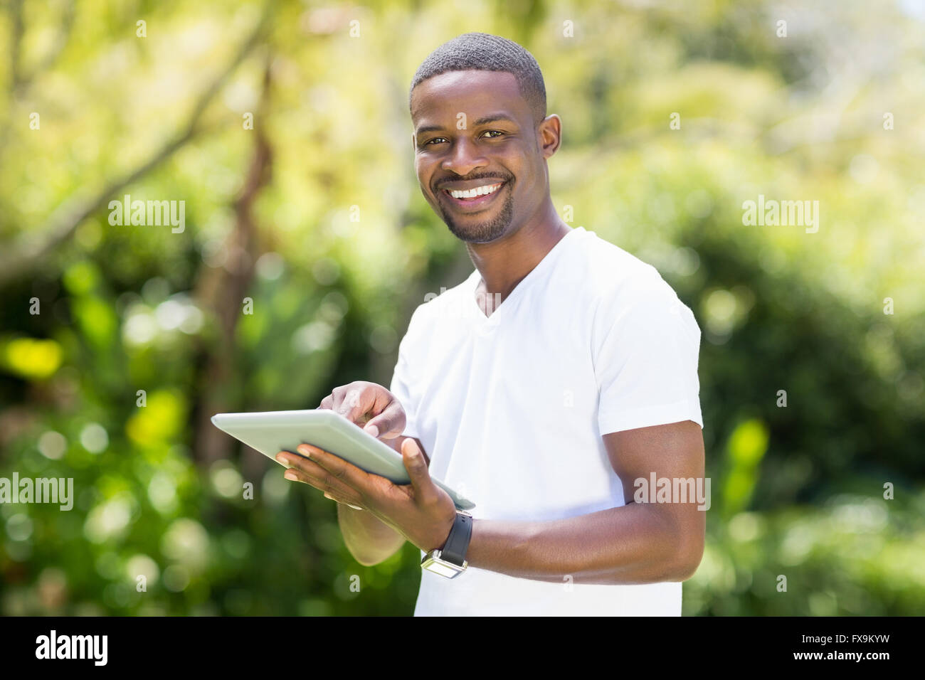 Happy man using a tablet Stock Photo - Alamy