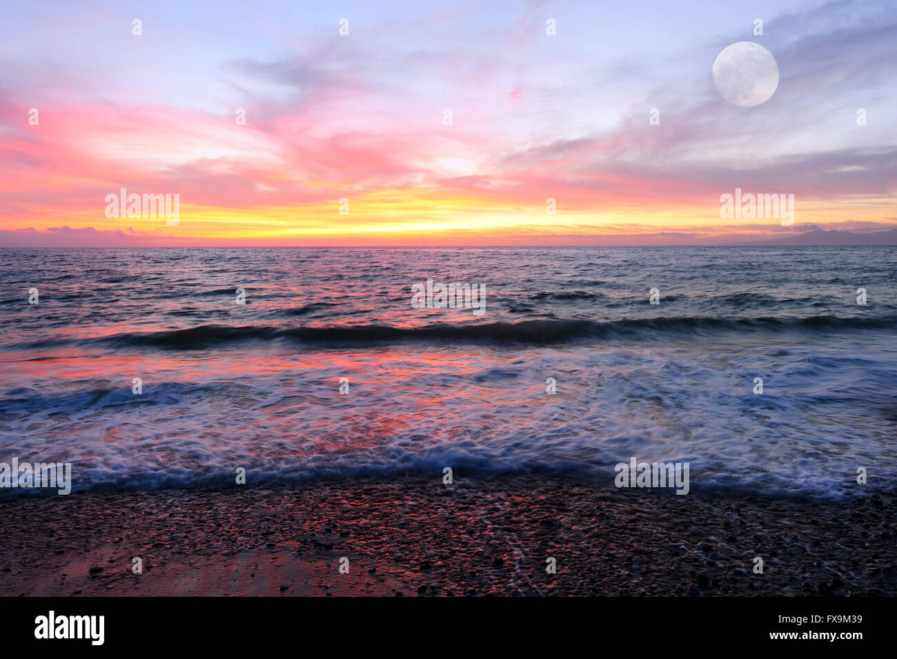Ocean sunset is brightly lit and golden seascape with a gentle wave ...