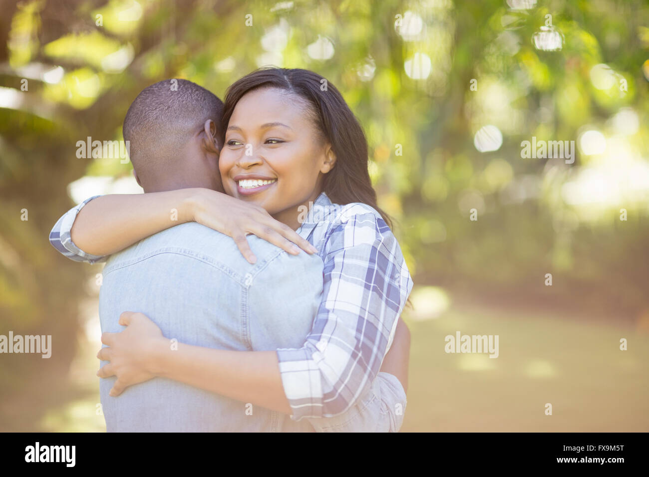Happy couple having hug Stock Photo - Alamy
