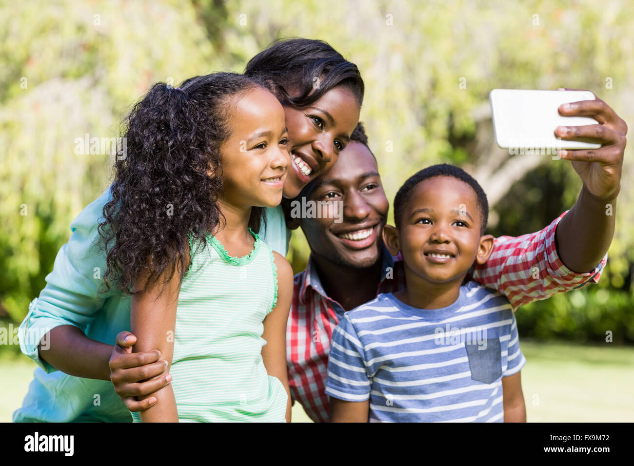 Happy family taking picture Stock Photo - Alamy