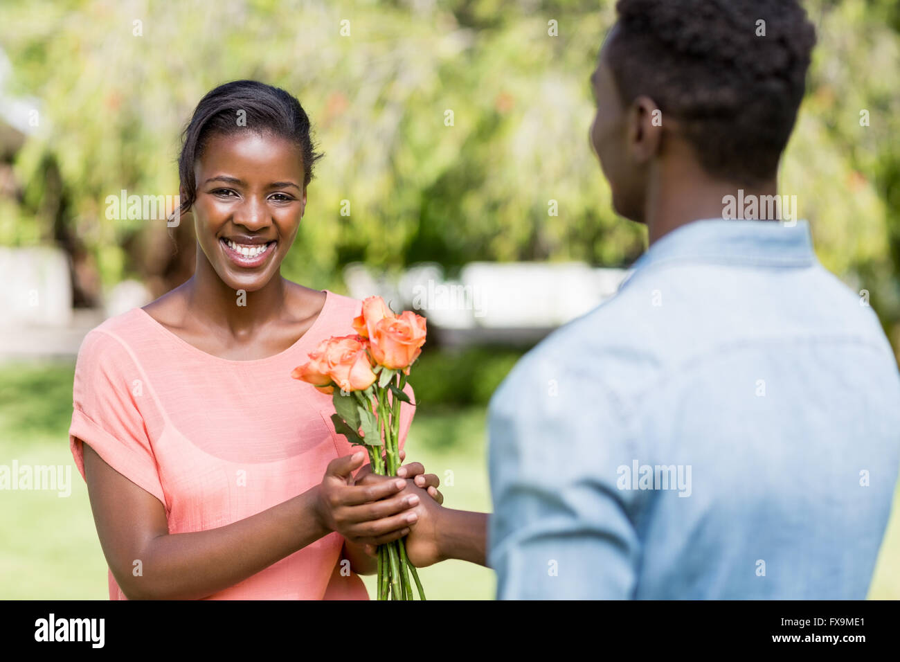 Happy woman having flowers Stock Photo - Alamy
