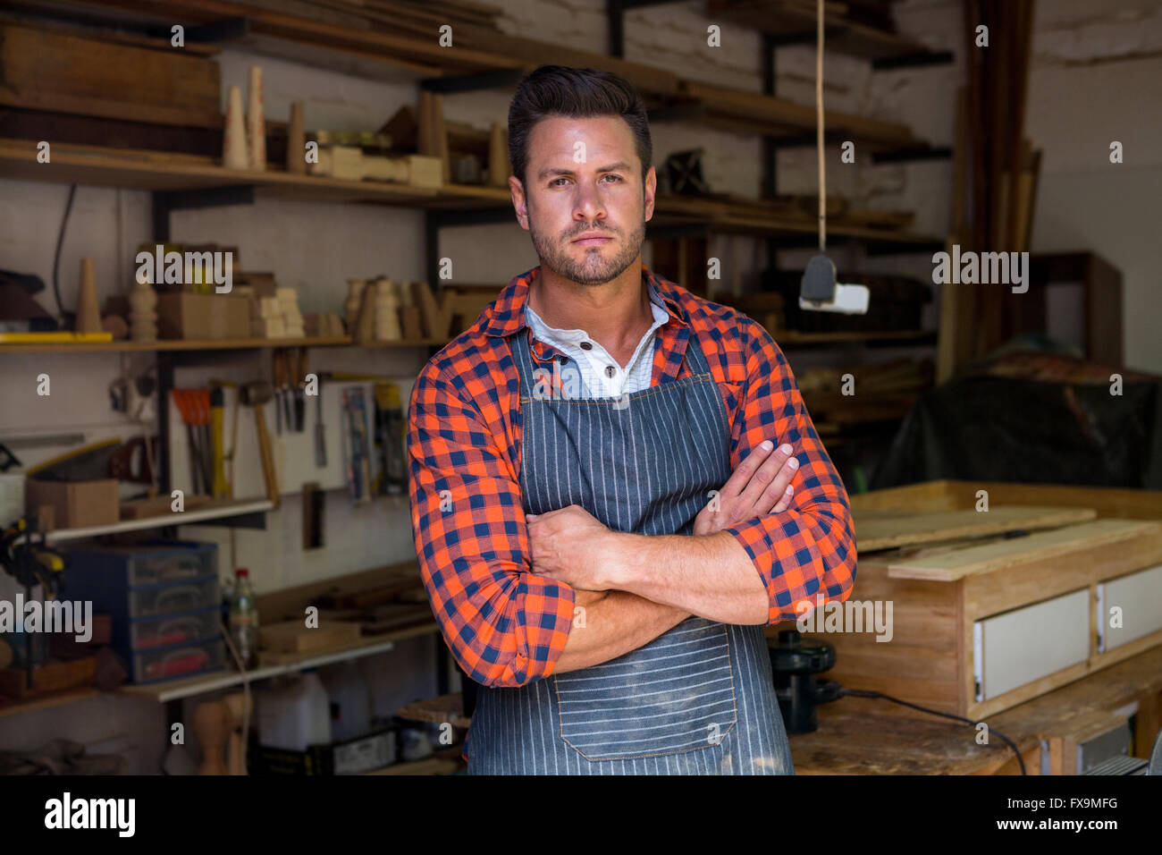 Carpenter is posing with his craft Stock Photo - Alamy