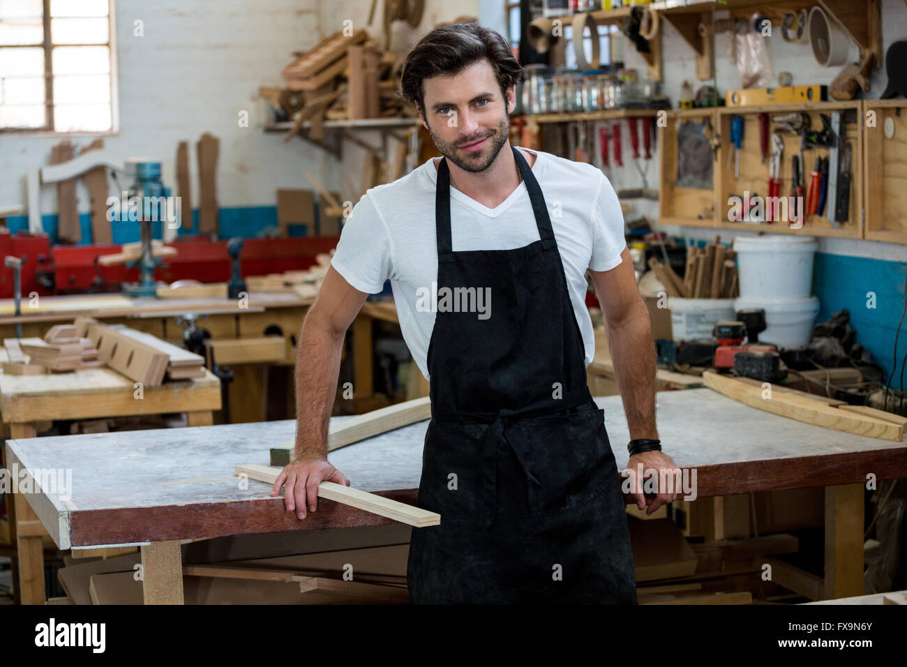Carpenter is posing with his craft Stock Photo - Alamy