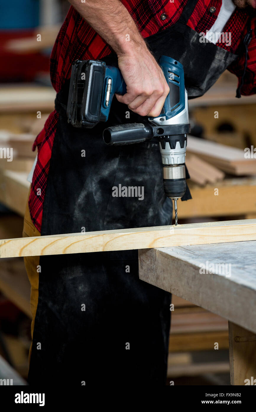 Carpenter using a drill Stock Photo - Alamy