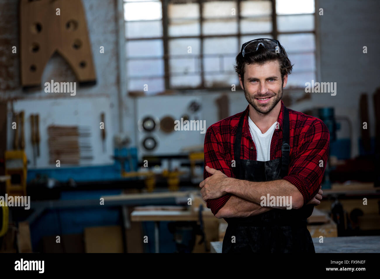 Carpenter smiling and crossing arms Stock Photo - Alamy