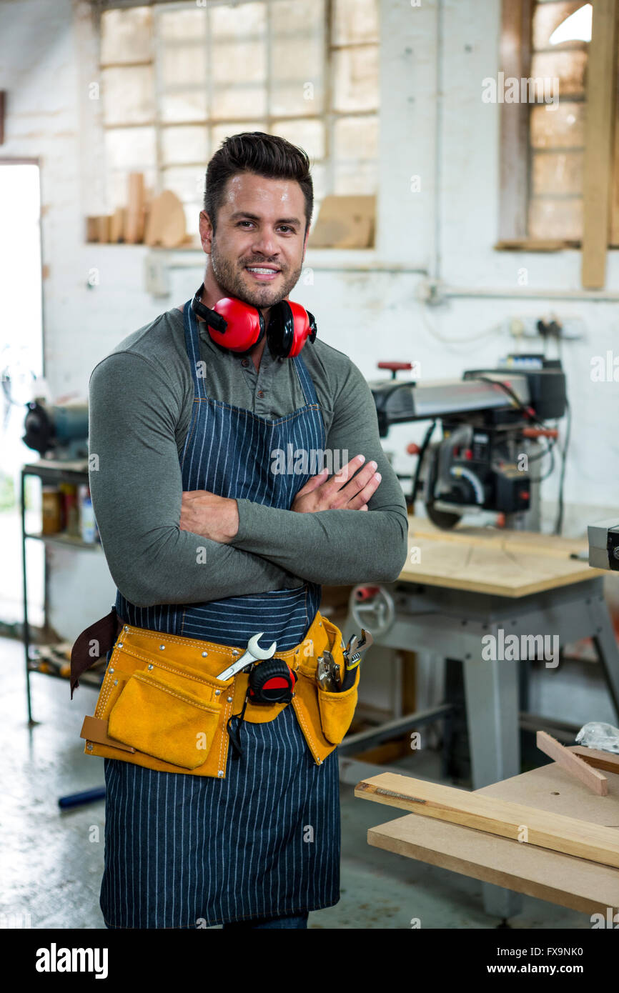 Carpenter smiling and crossing arms Stock Photo - Alamy