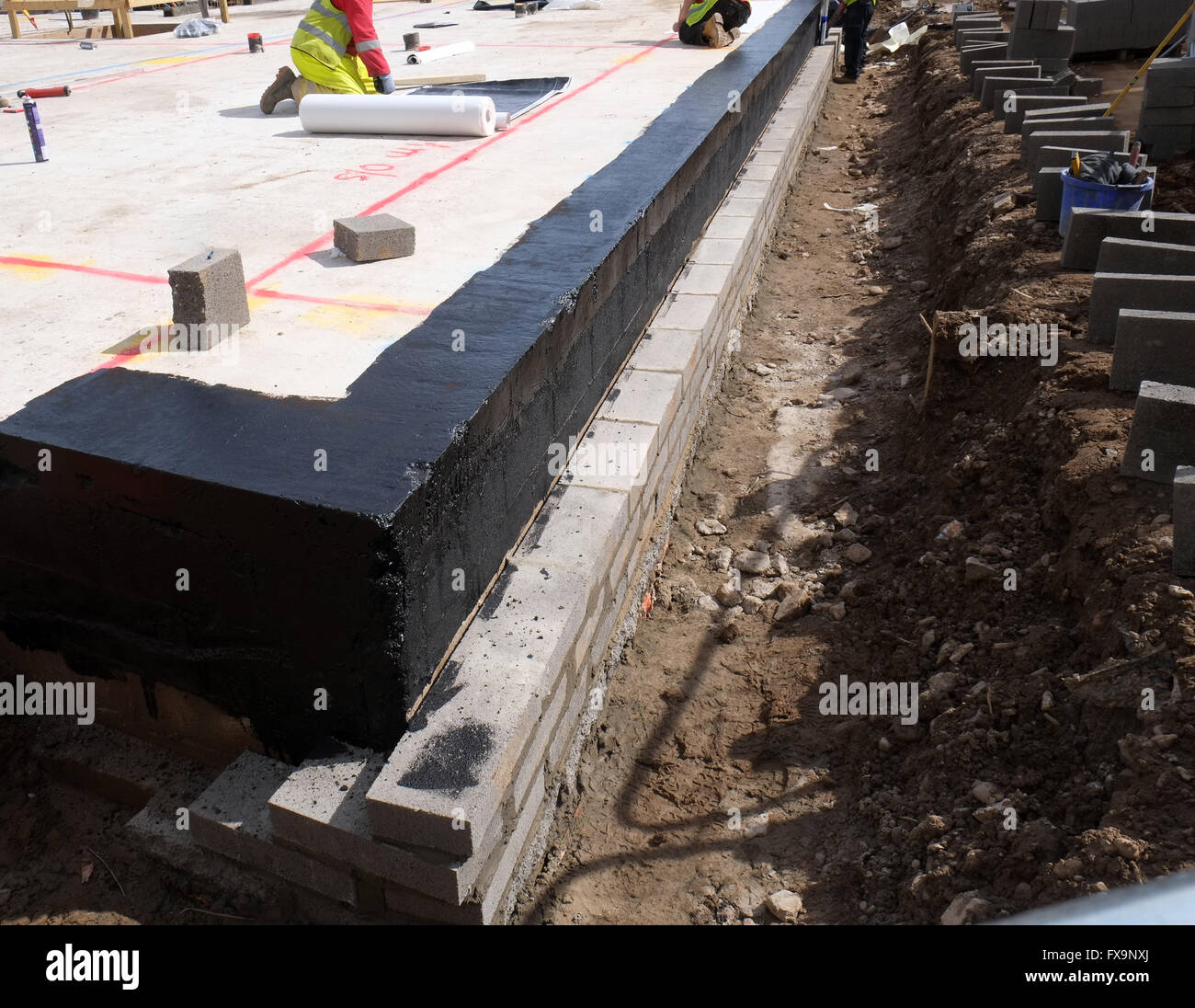 Blockwork wall under construction with a waterproof layer behind April ...