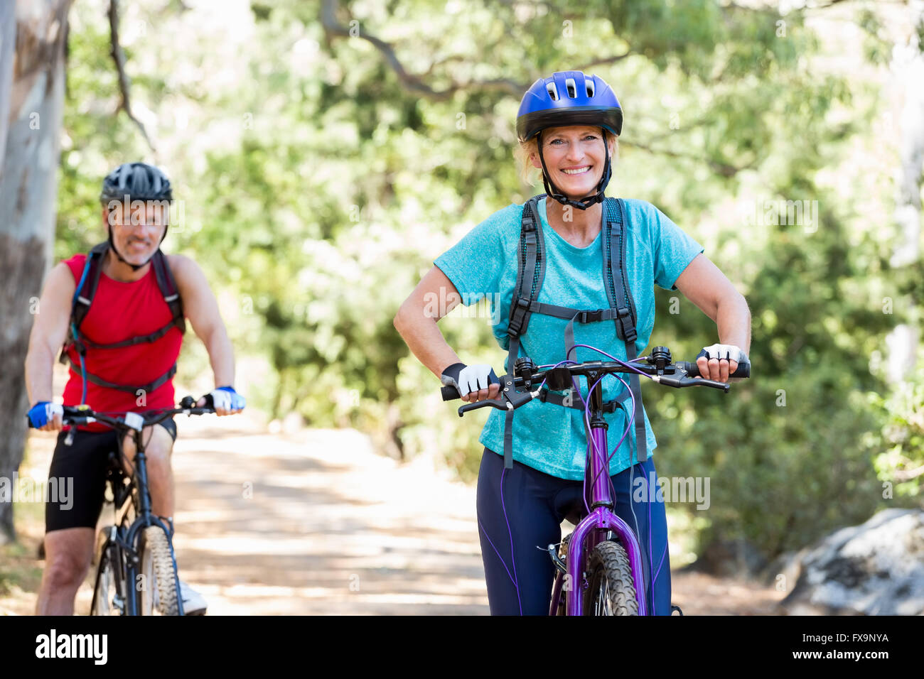 Senior couple standing with their bike Stock Photo - Alamy
