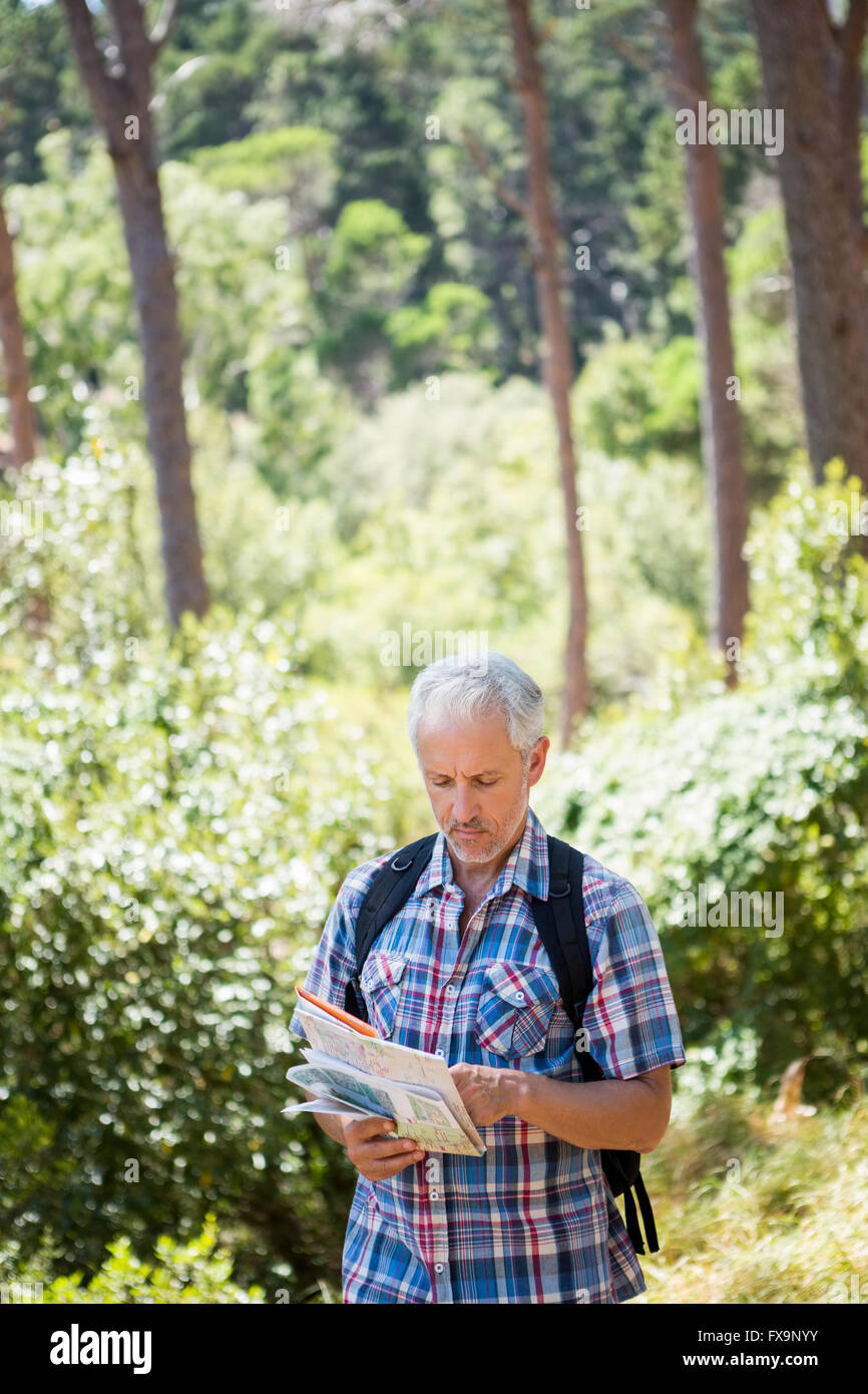 senior man is standing and carrying a map Stock Photo - Alamy