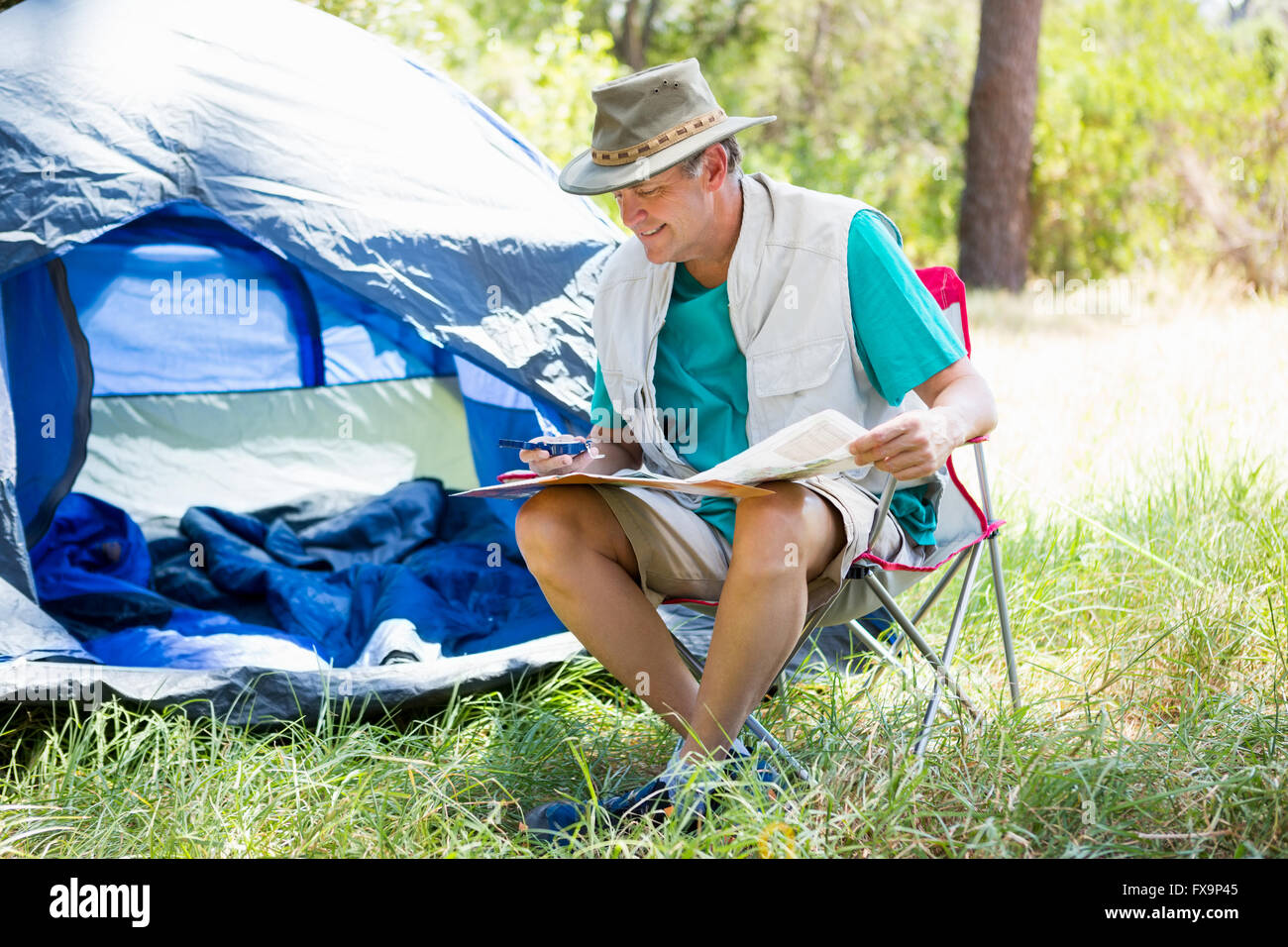 senior man reading beside his tent Stock Photo - Alamy