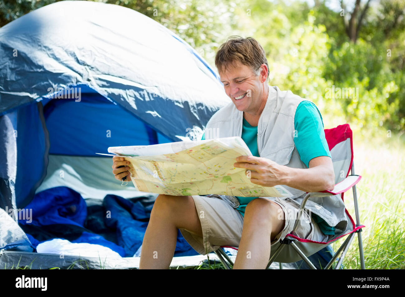 senior man reading beside his tent Stock Photo - Alamy
