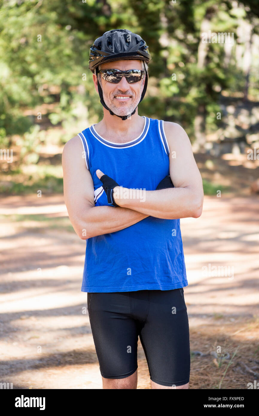 Mature bike rider man posing with arms crossed Stock Photo - Alamy