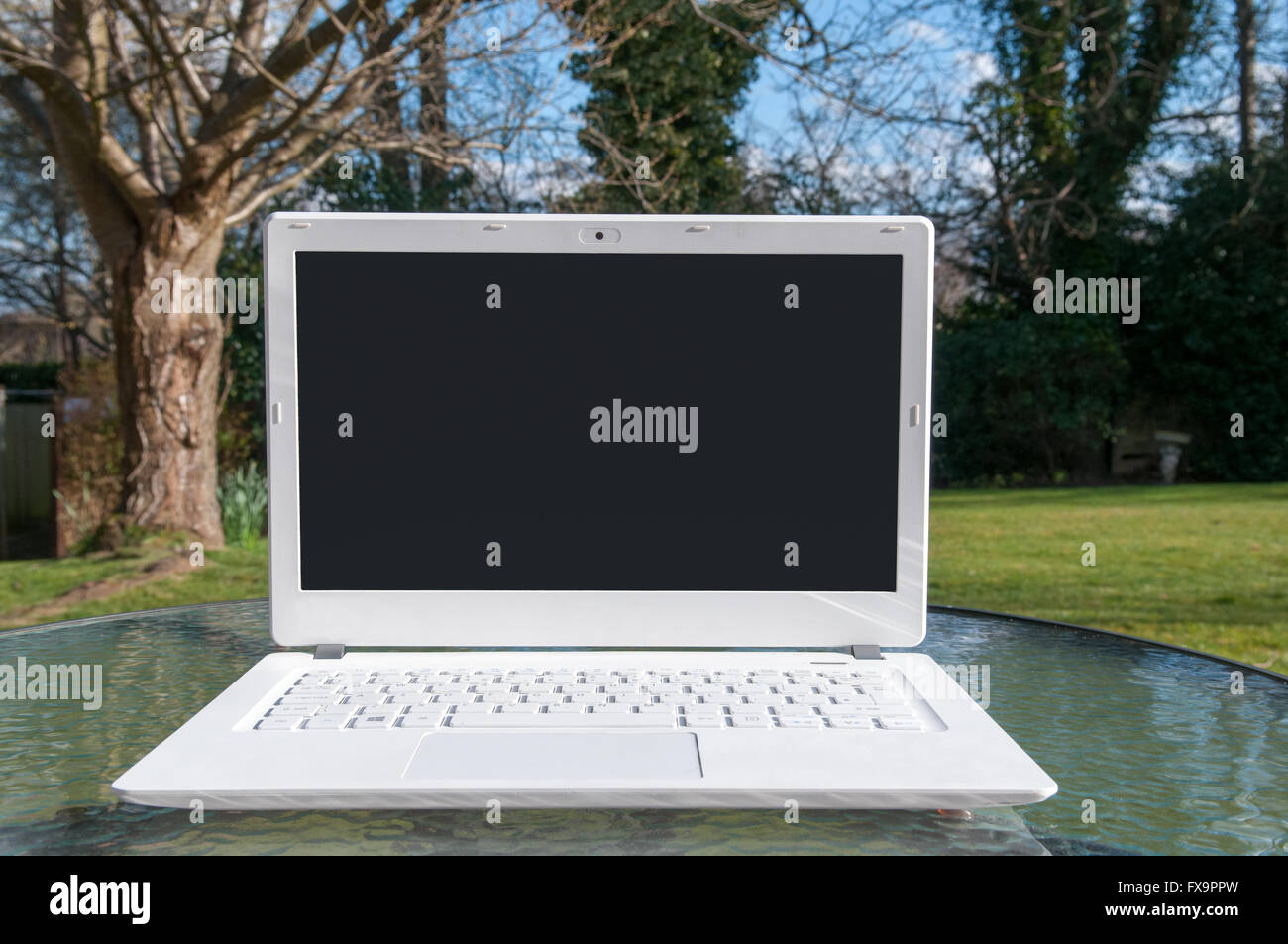 Modern laptop with a blank screen outside on a sunny day Stock Photo ...