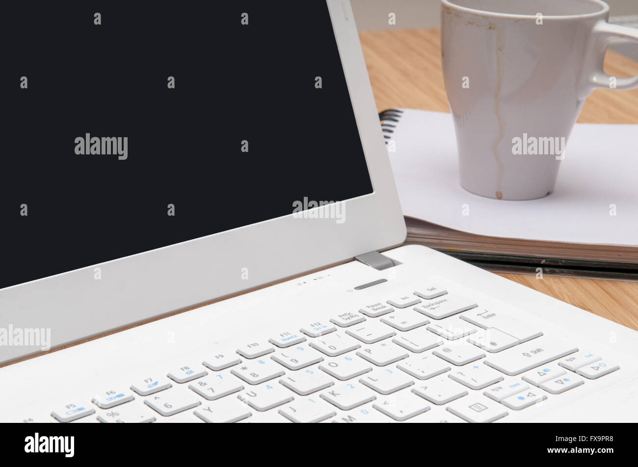 Laptop and notepad on the table Stock Photo - Alamy