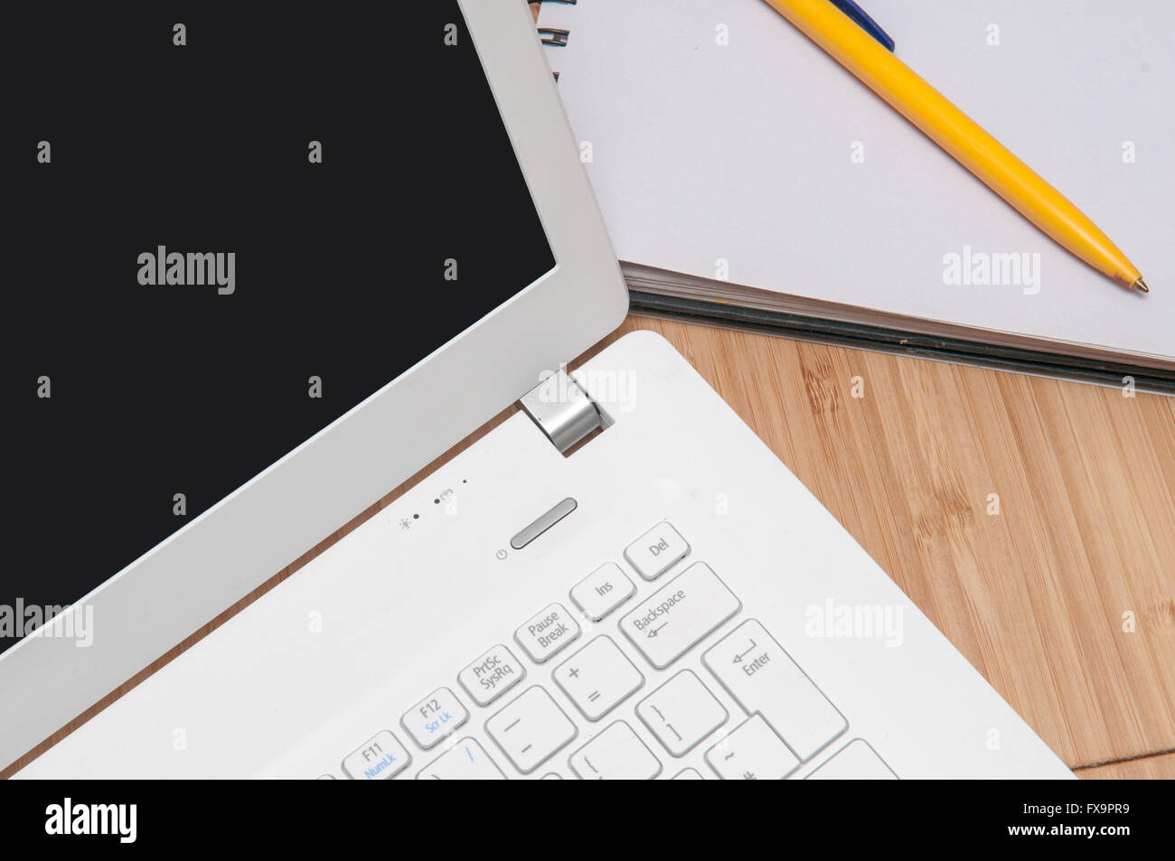 Laptop and notepad on the table with blank screen and pages Stock Photo ...